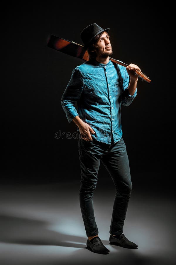 Cool Guy Standing with Guitar on Dark Background Stock Photo - Image of ...