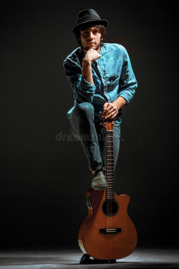 Cool Guy Standing With Guitar On Dark Background Stock Image - Image of ...