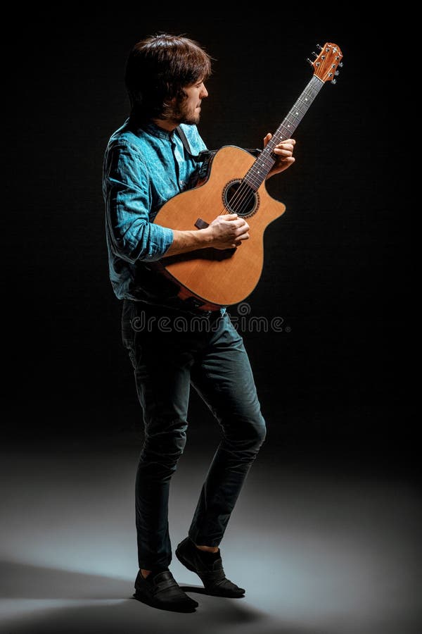 Cool Guy Standing with Guitar on Dark Background Stock Image - Image of ...