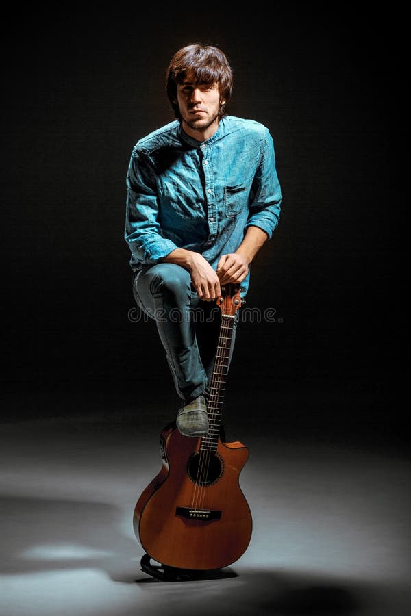 Cool Guy Standing with Guitar on Dark Background Stock Photo - Image of ...