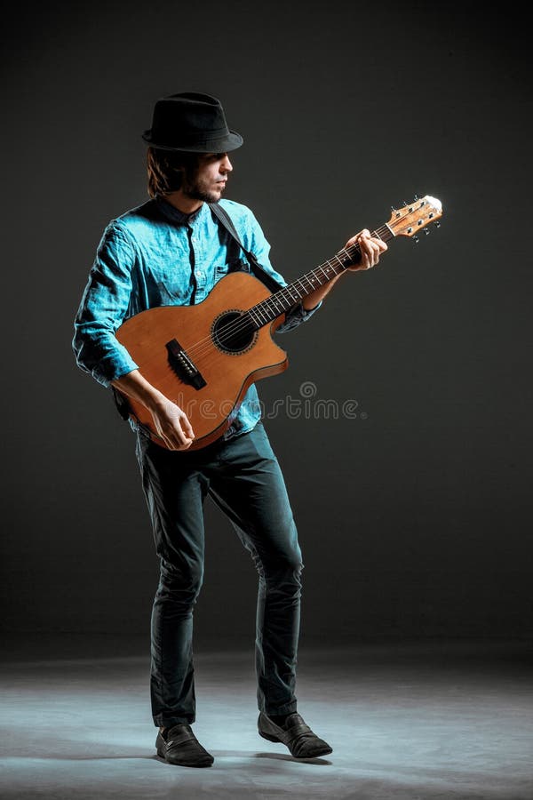 Cool Guy Standing with Guitar on Dark Background Stock Photo - Image of ...
