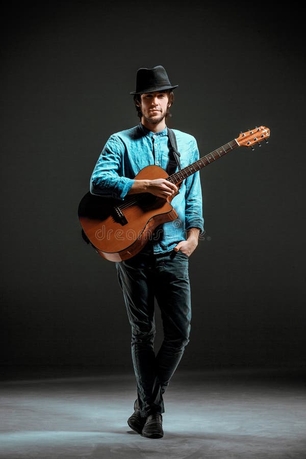 Cool Guy Standing with Guitar on Dark Background Stock Image - Image of ...