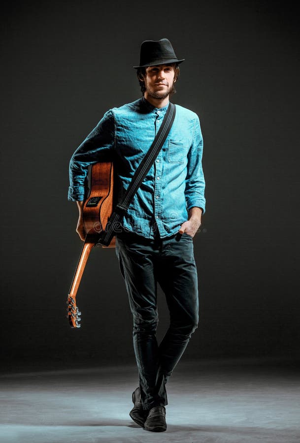 Cool Guy Standing with Guitar on Dark Background Stock Photo - Image of ...
