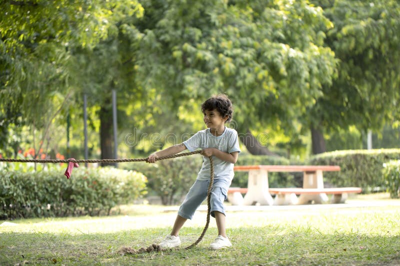Cool Kid Pulling Rope in the Garden Stock Image - Image of young ...