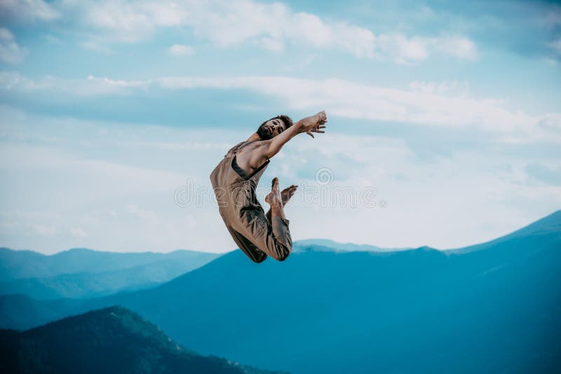 Cool Looking Dancer Makes a Difficult Jump Against Blue Sky Stock Image ...