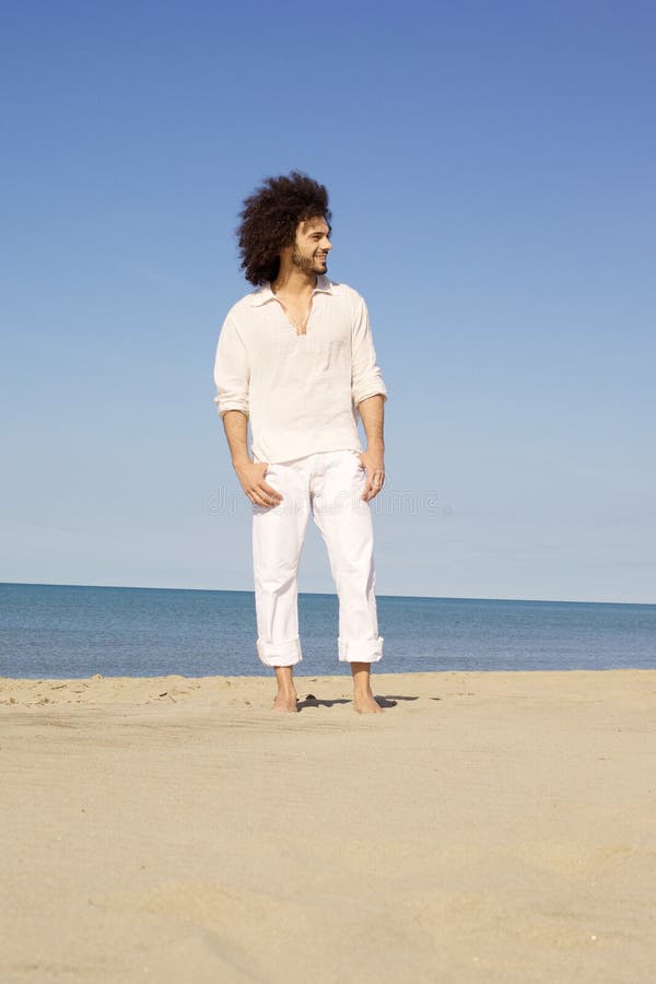 Cool Man Smiling Standing on Sand in Front of the Ocean Stock Image ...