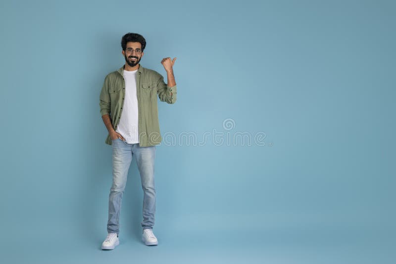 Millennial Guy Pointing Fingers Upward in Excitement Over Yellow ... Millennial Guy Pointing Fingers Upward in Excitement Over Yellow ...