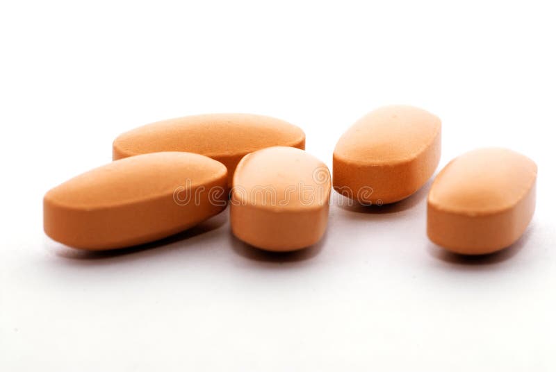 Orange Oval Pills on White Background Stock Photo - Image of supplement ...