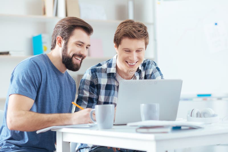 Cheerful Male Colleagues Emerging in Project Stock Image - Image of ...