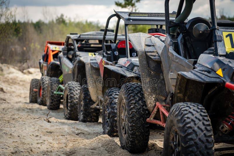 Cool Quads Stand in a Row on Sand before Competition Stock Photo ...