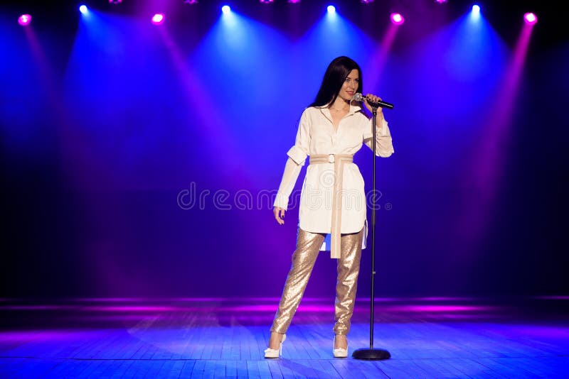 Cool Singer with Microphone on Bright Backlit Stage in Bright Blue ...