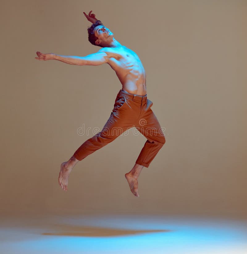 Cool Young Guy Dancing and Floating in a Jump in Neon Light. Dance ...