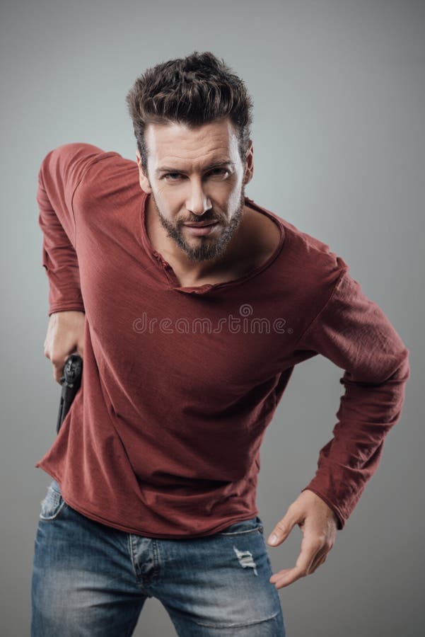 Cool Young Man Holding a Gun Stock Image - Image of suspicion, handgun ...