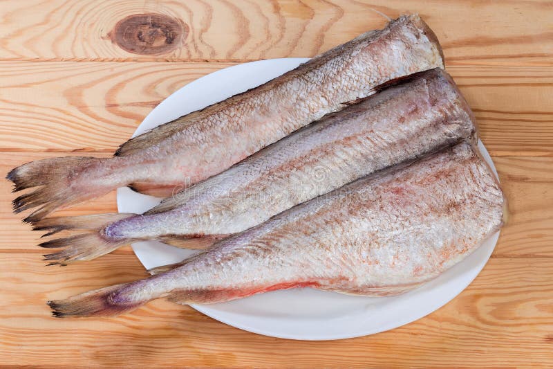 Cooled Carcasses of Red Cod on Dish on Rustic Table Stock Photo - Image ...