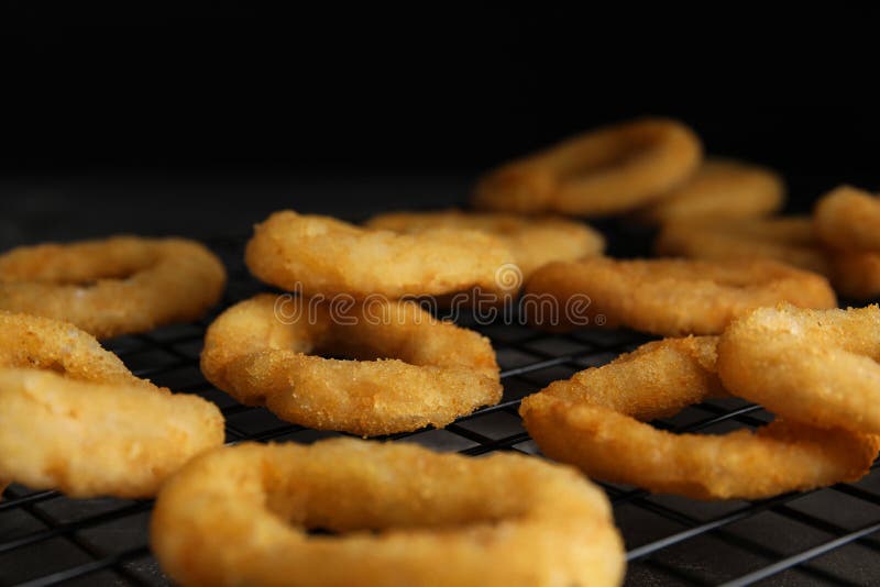 Cooling Rack with Fried Onion Rings on Table, Closeup Stock Photo ...