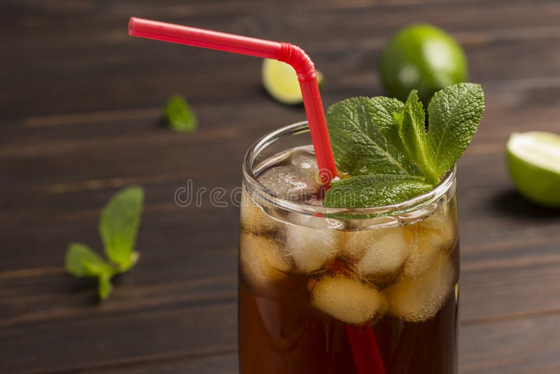 Cooling Summer Tea with Ice and Mint. Red Straw in Glass Stock Photo ...