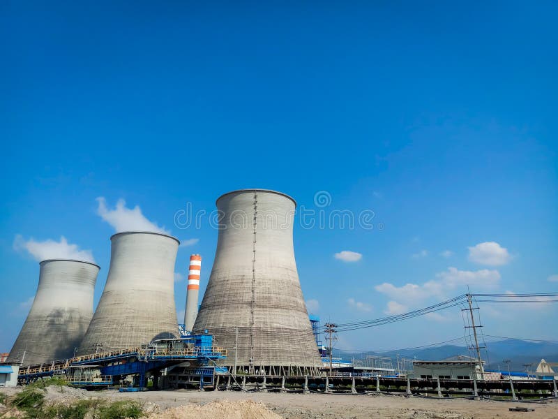 The Cooling Tower of the Power Plant on the Backdrop of the Blue Sky ...
