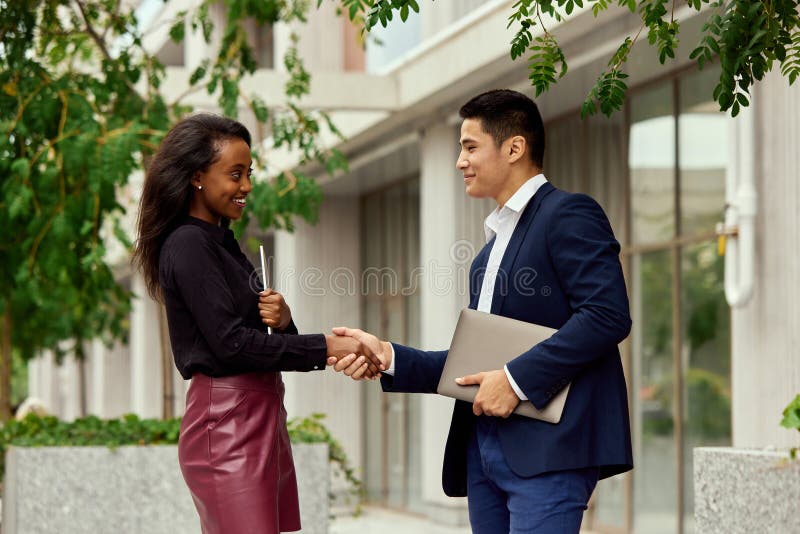 Cooperation and Partnership. Man and Woman, Managers Shaking Hands in ...