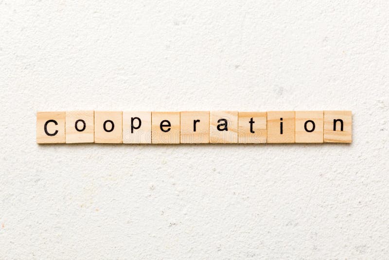 Cooperation Word Written on Wood Block. Cooperation Text on Table ...
