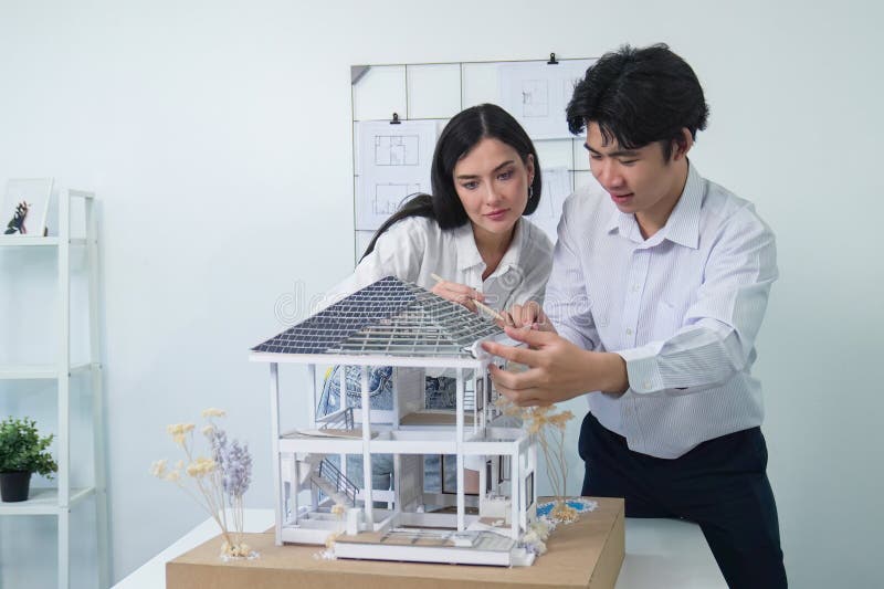 Cooperative Engineer Team Working Together To Measure House Model ...