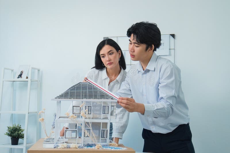 Cooperative Engineer Team Working Together To Measure House Model ...