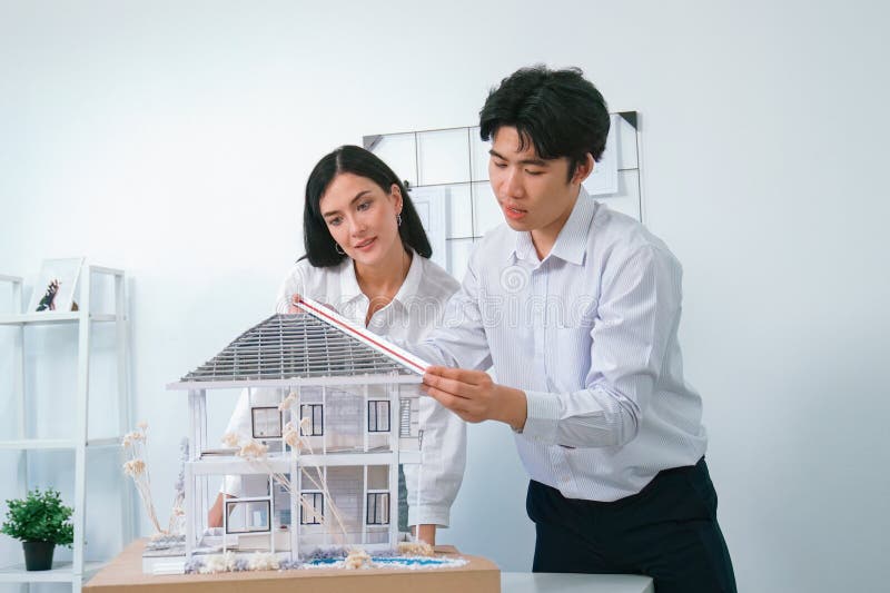 Cooperative Engineer Team Working Together To Measure House Model ...