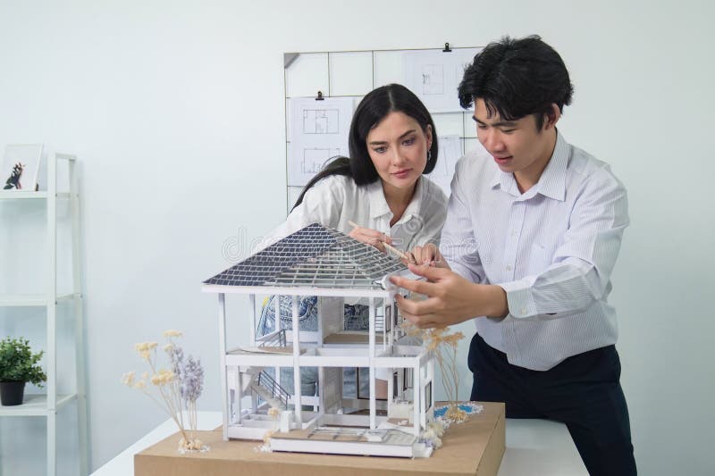 Cooperative Engineer Team Working Together To Measure House Model ...