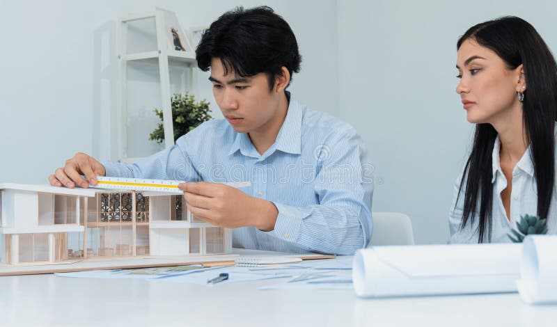 Cooperative Engineer Team Working Together To Measure House Model ...