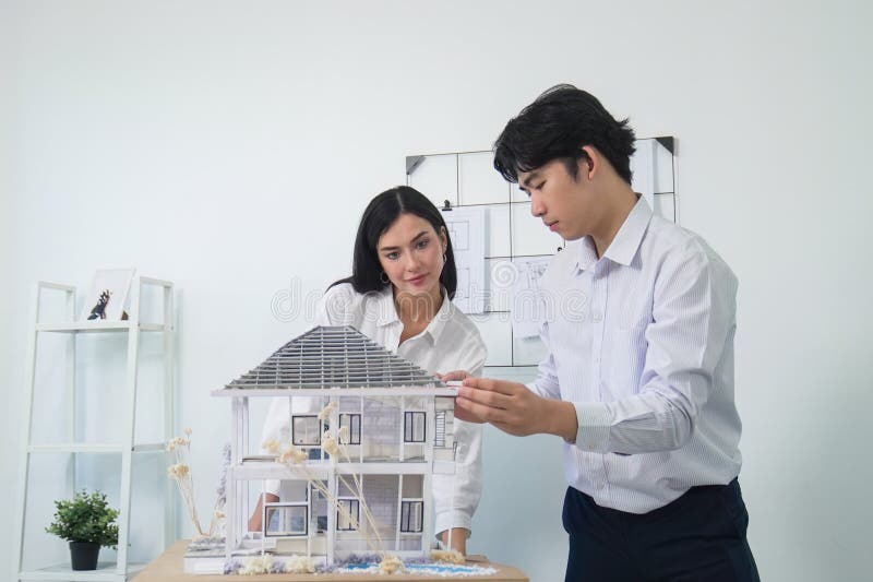 Cooperative Engineer Team Working Together To Measure House Model ...