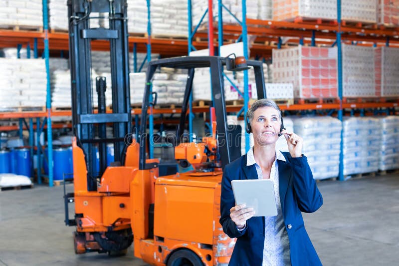 Coordinating Logistics, Warehouse Manager Using Tablet and Headset with ...