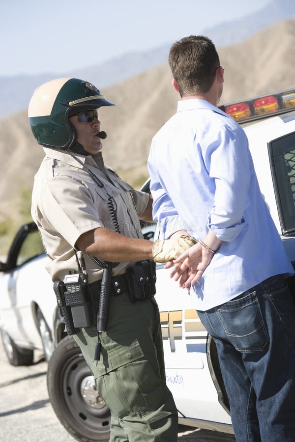 Traffic Cop Arresting Man stock photo. Image of people - 29651266