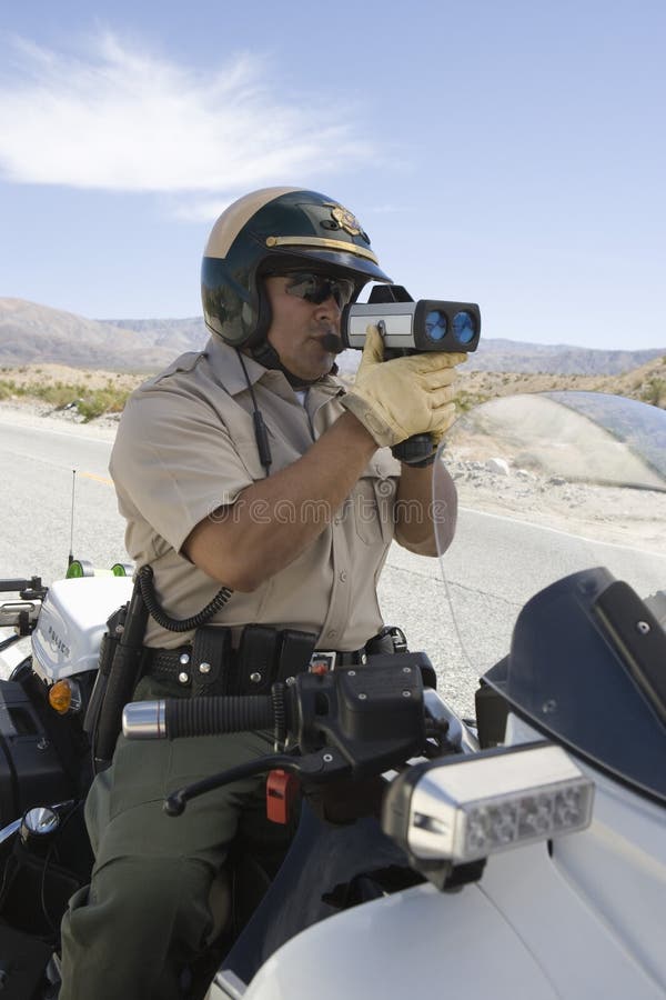 Cop Monitoring Speed Though Radar Gun Stock Photo - Image of authority ...