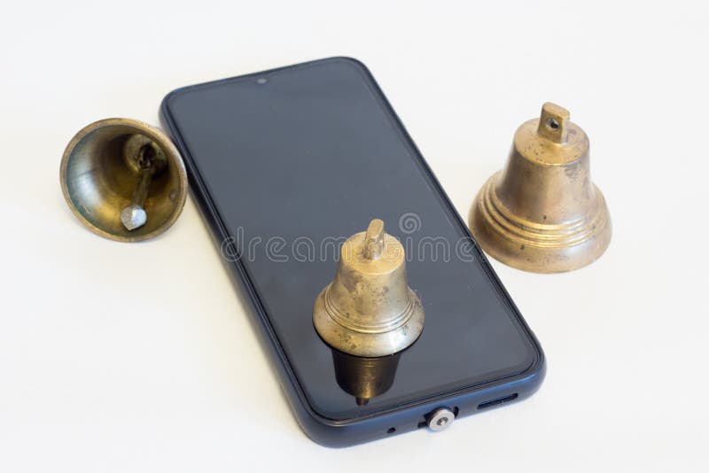 Copper Bell on Top of a Cell Phone Stock Image - Image of reminder ...
