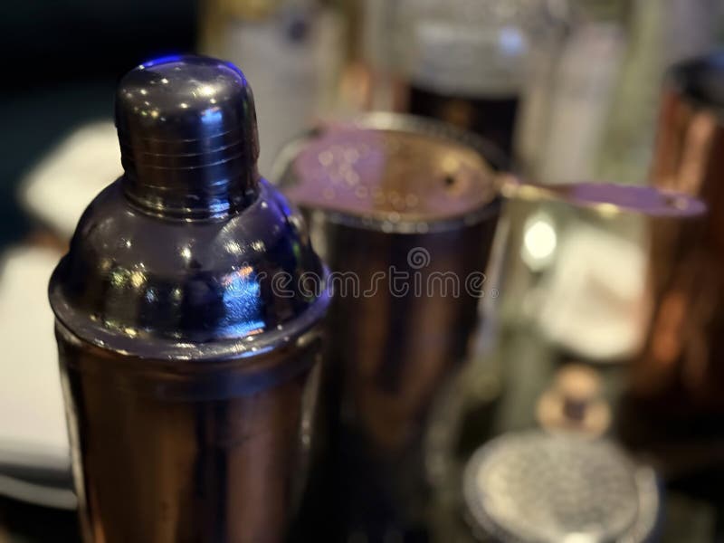 Copper Cocktail Shaker and Bar Tools at a Lively Evening Event Stock ...