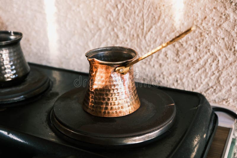 Copper Coffee Pot on Electric Stove. Turkish Coffee in the Cezve Stock ...