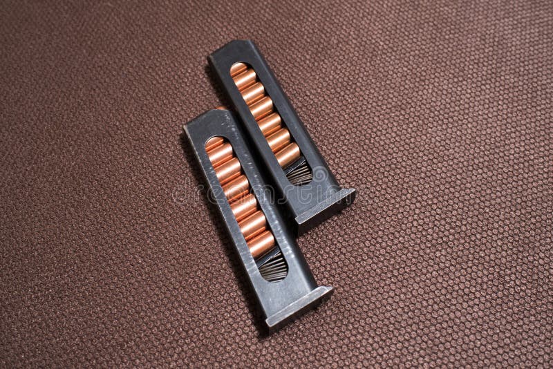 Copper Firearms Bullets and Pistol Clips. Weapon. Stock Photo - Image ...
