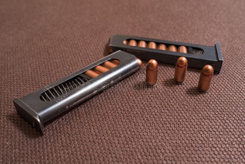 Copper Firearms Bullets and Pistol Clips. Weapon. Stock Image - Image ...