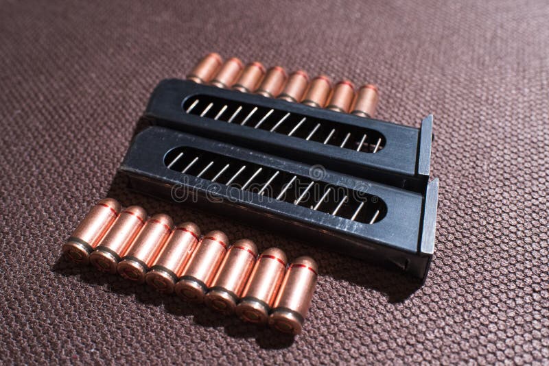 Copper Firearms Bullets and Pistol Clips. Weapon. Stock Photo - Image ...