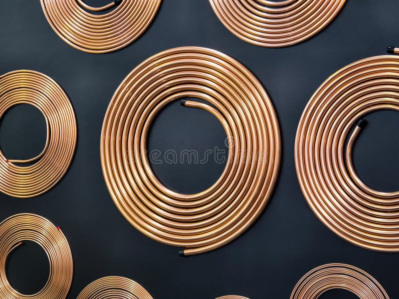 Copper Pipes Arranged in Concentric Circles on a Dark Wall Create a ...