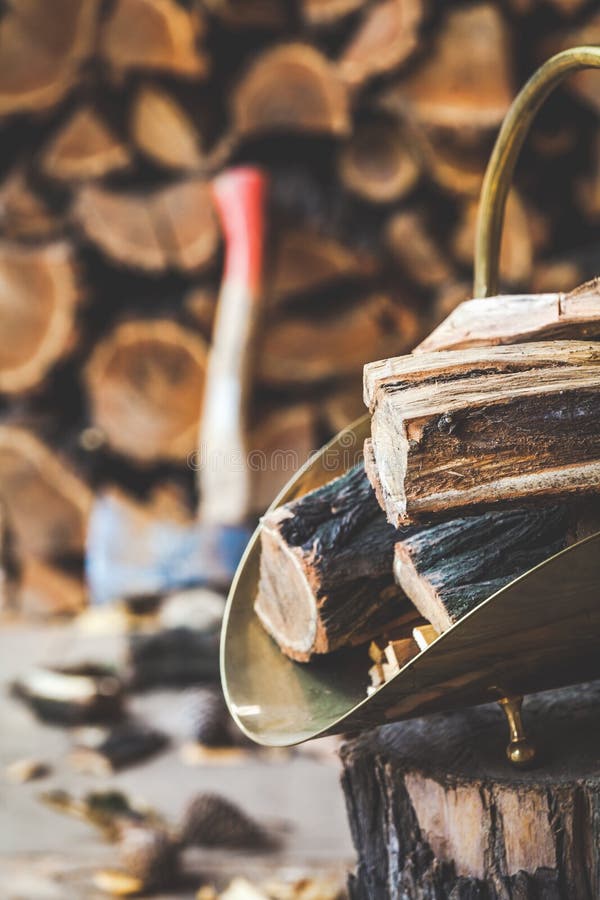 An Ax Stands on a Stump Amid Stacked Chopped Firewood Stock Photo ...
