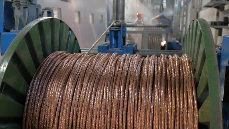 Winding a Copper Cable on a Rotating Coil. Production of Electric Cable ...