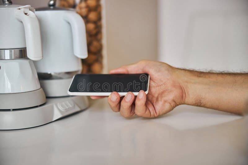 Owner of Smart Kettle Switching it on with a Smartphone Stock Image ...