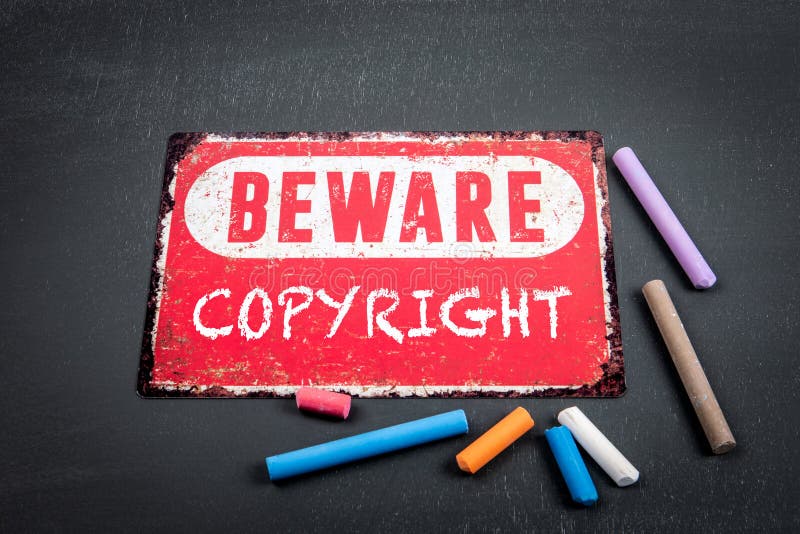Copyright. Beware Sign with Text and Colored Pieces of Chalk on a Dark ...
