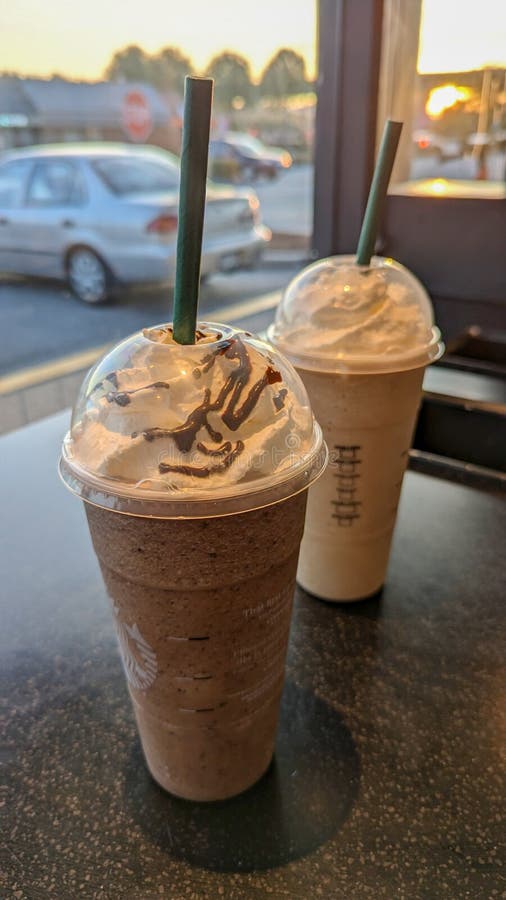 Two Ice Coffees on a Table at a Starbucks Store with Blurred People in ...