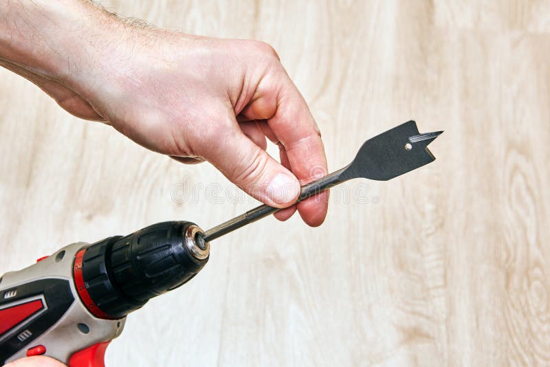 Cordless Drill with Spade Bit Held by Hand. Stock Photo - Image of ...