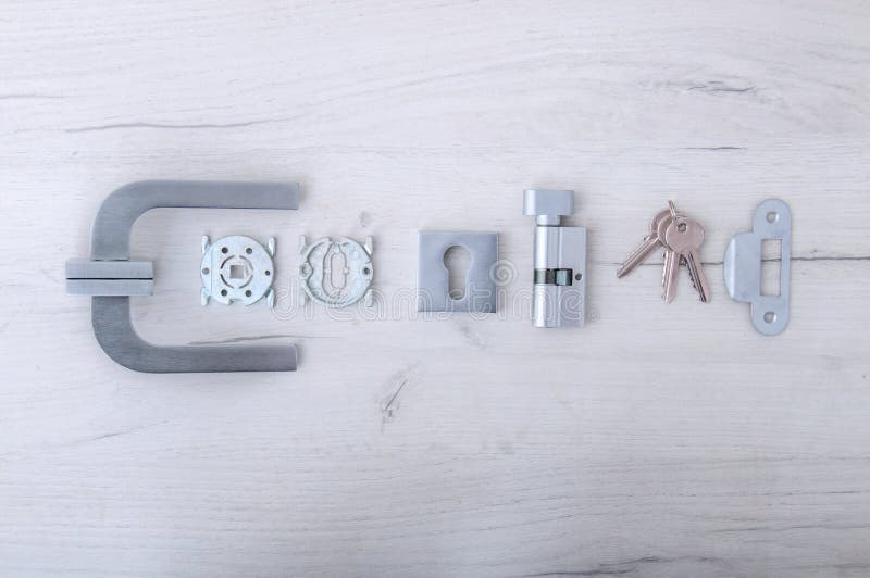 The Core of the Lock, Handles and Door Keys on a Light Background ...