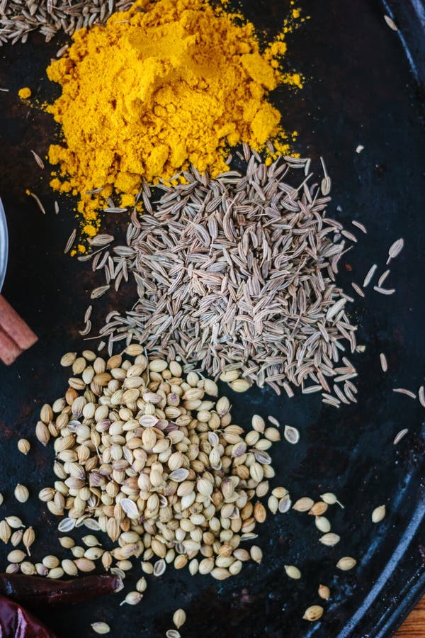 Coriander, Cumin and Turmeric Spices Over Black Metal Plate. Stock ...