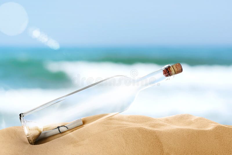 Corked Glass Bottle with Rolled Paper Note on Sandy Beach Near Ocean ...