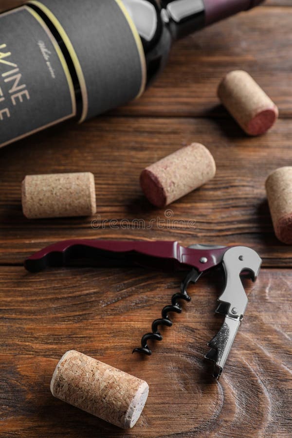 Corkscrew, Wine Bottle and Stoppers on Wooden Table Stock Image - Image ...
