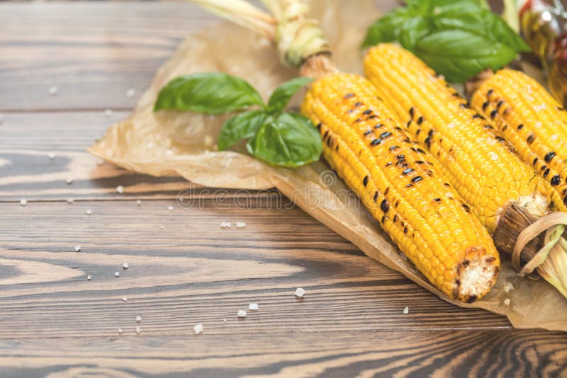 Corn Baked in Olive Oil, with Salt and Basil on Parchment Paper Stock ...
